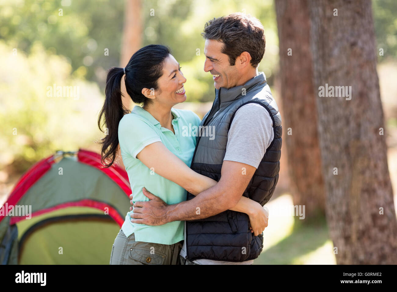 Couple smiling and holding each other Stock Photo - Alamy