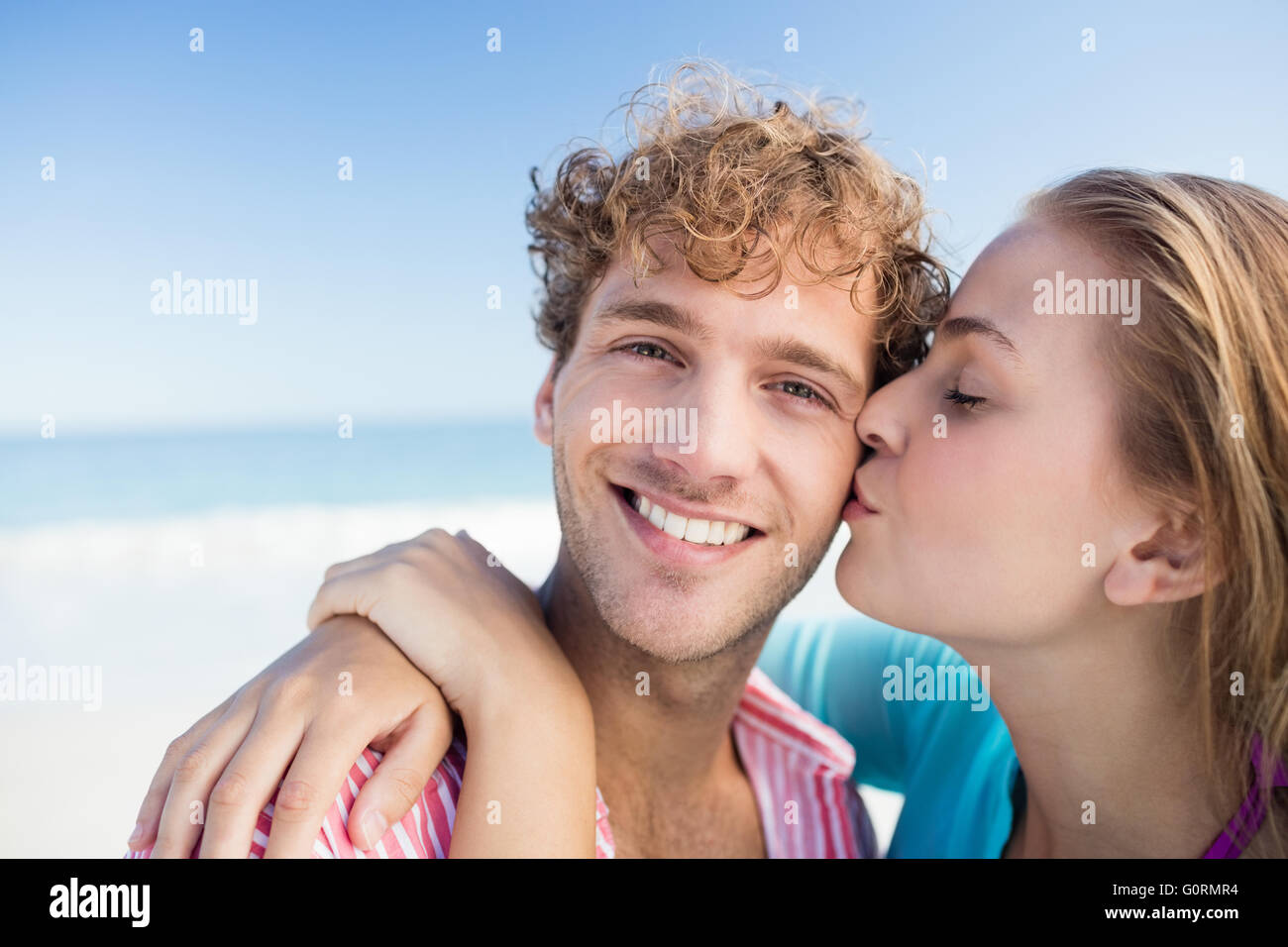 Happy couple embracing on the beach Stock Photo - Alamy
