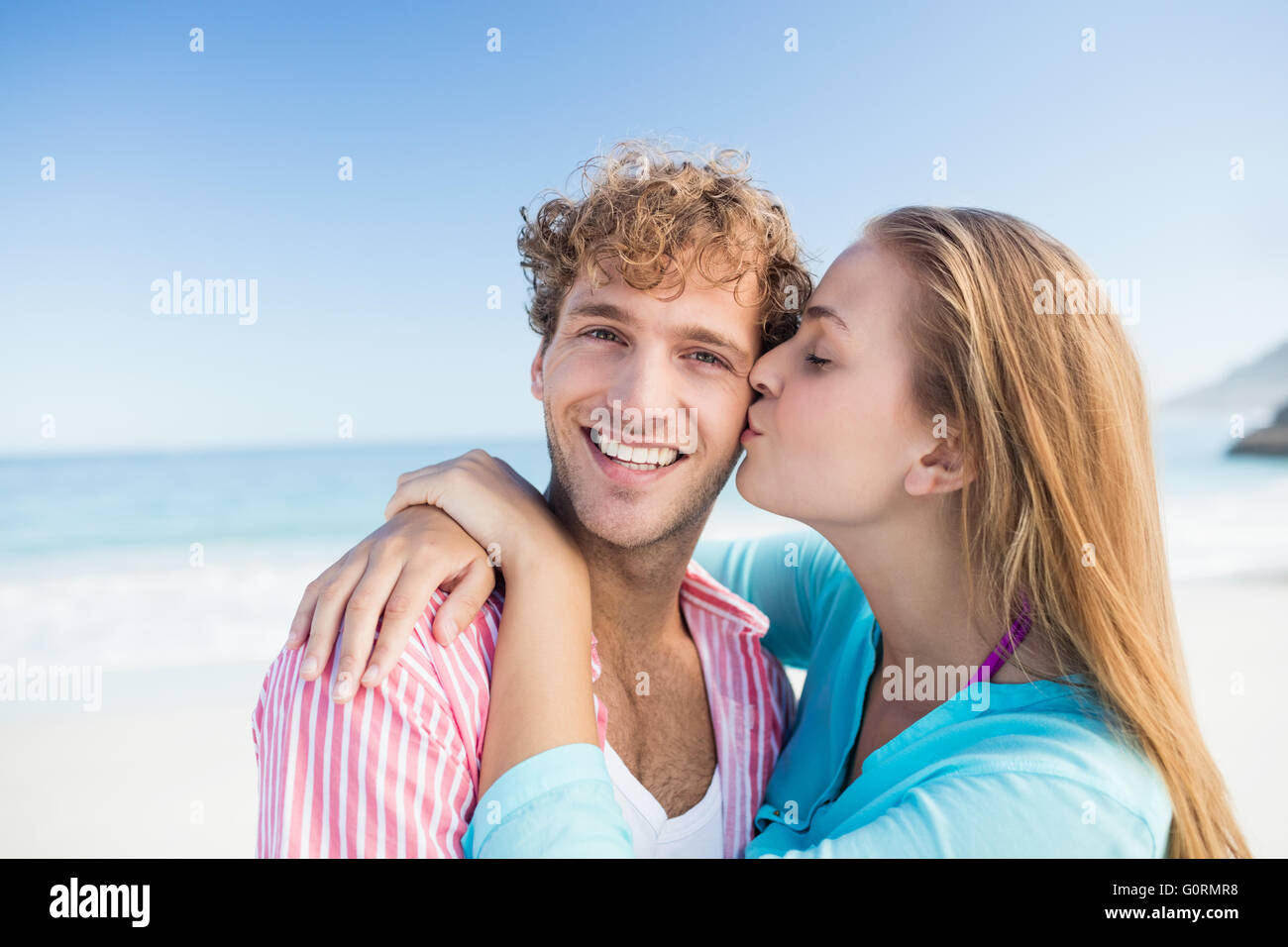 Happy couple embracing on the beach Stock Photo - Alamy