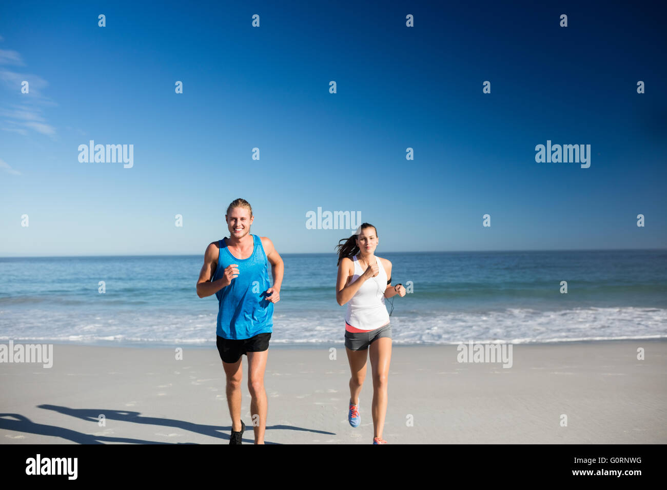 Friends jogging at the beach Stock Photo - Alamy