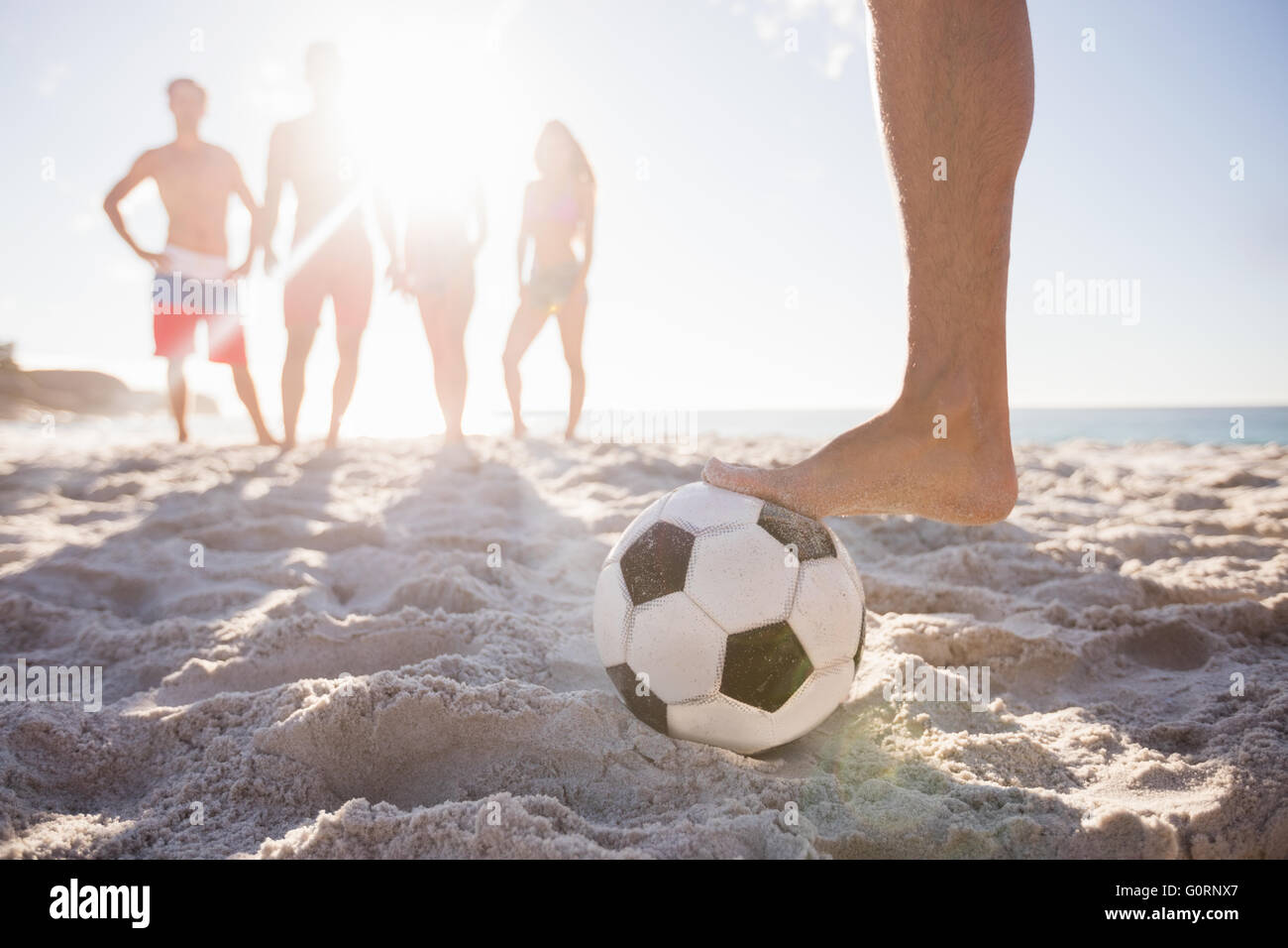 Friends playing football Stock Photo - Alamy