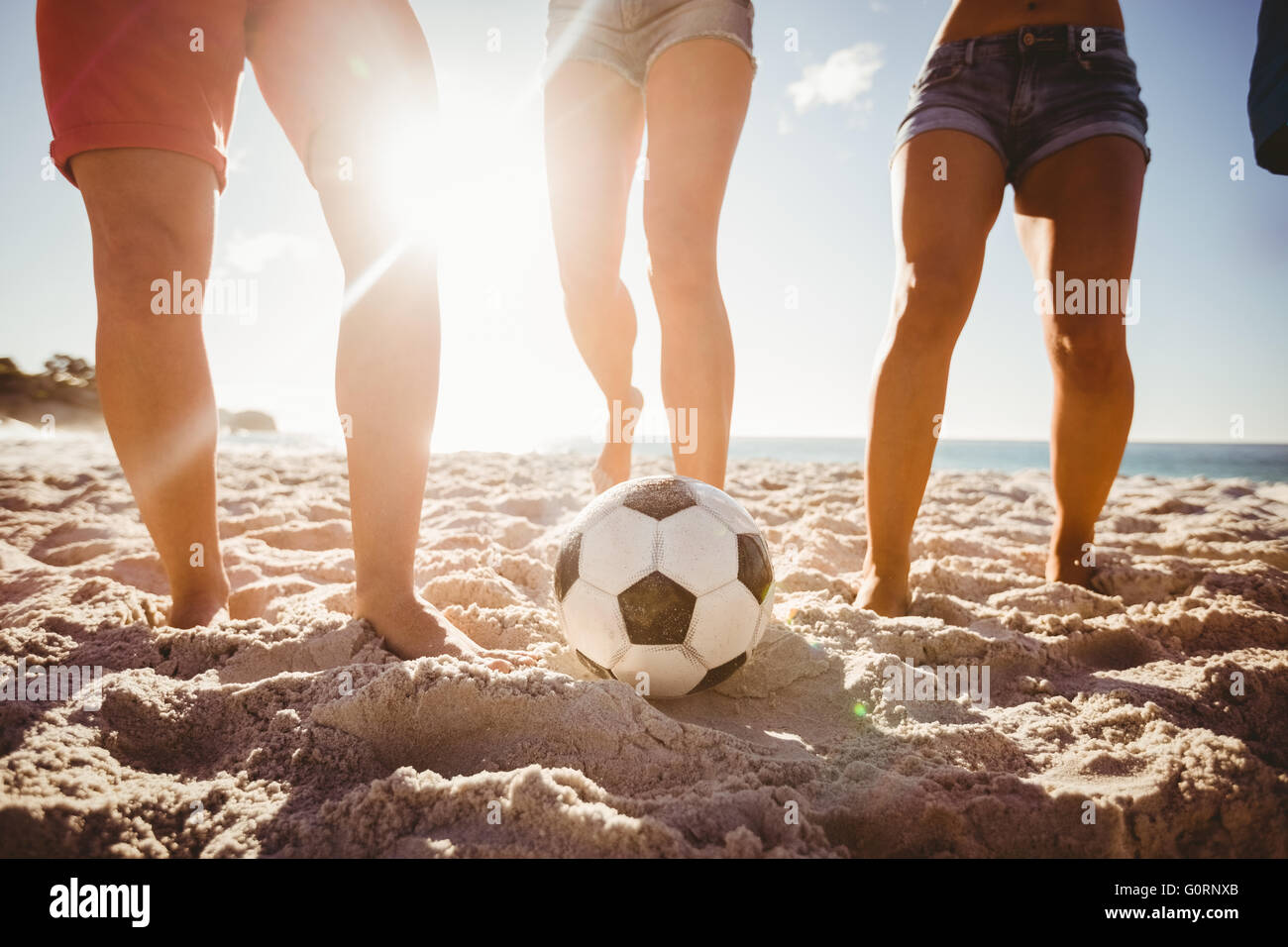 Friends playing football Stock Photo - Alamy