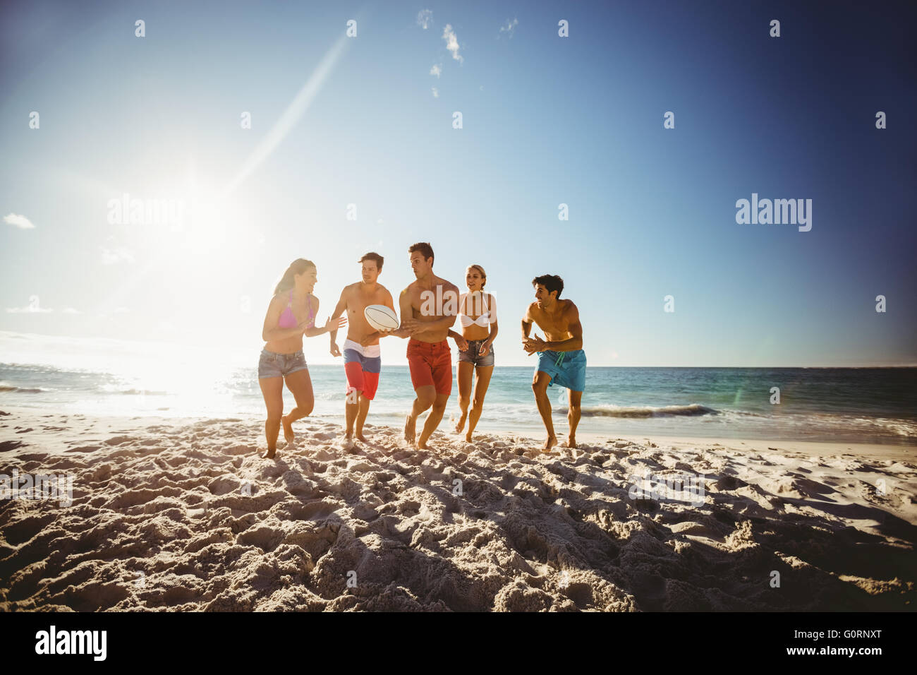 Friends playing rugby Stock Photo - Alamy