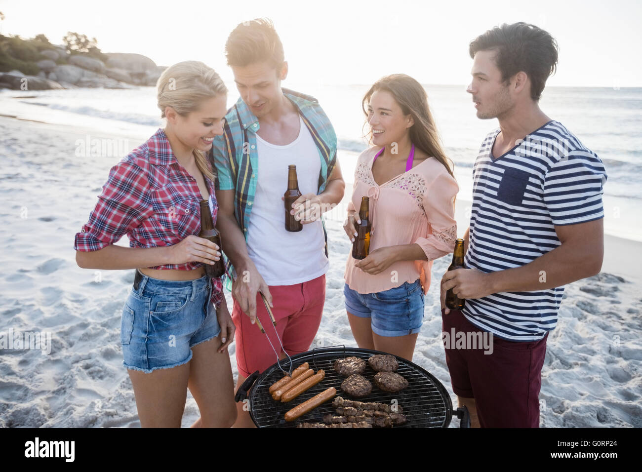 Friends having a barbecue Stock Photo - Alamy