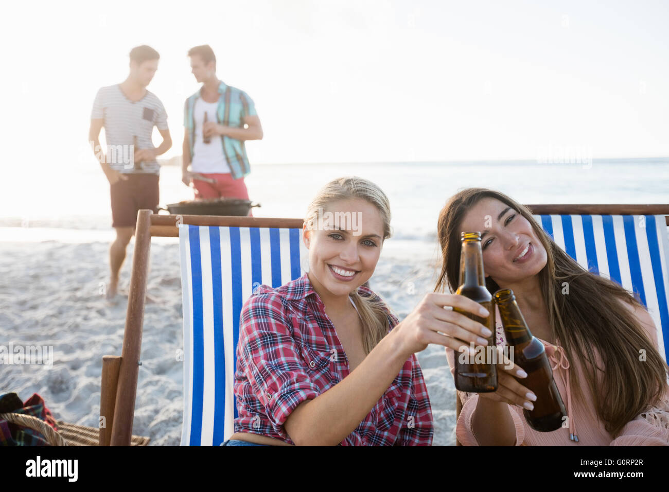 Smiling friends cheering with beer Stock Photo - Alamy