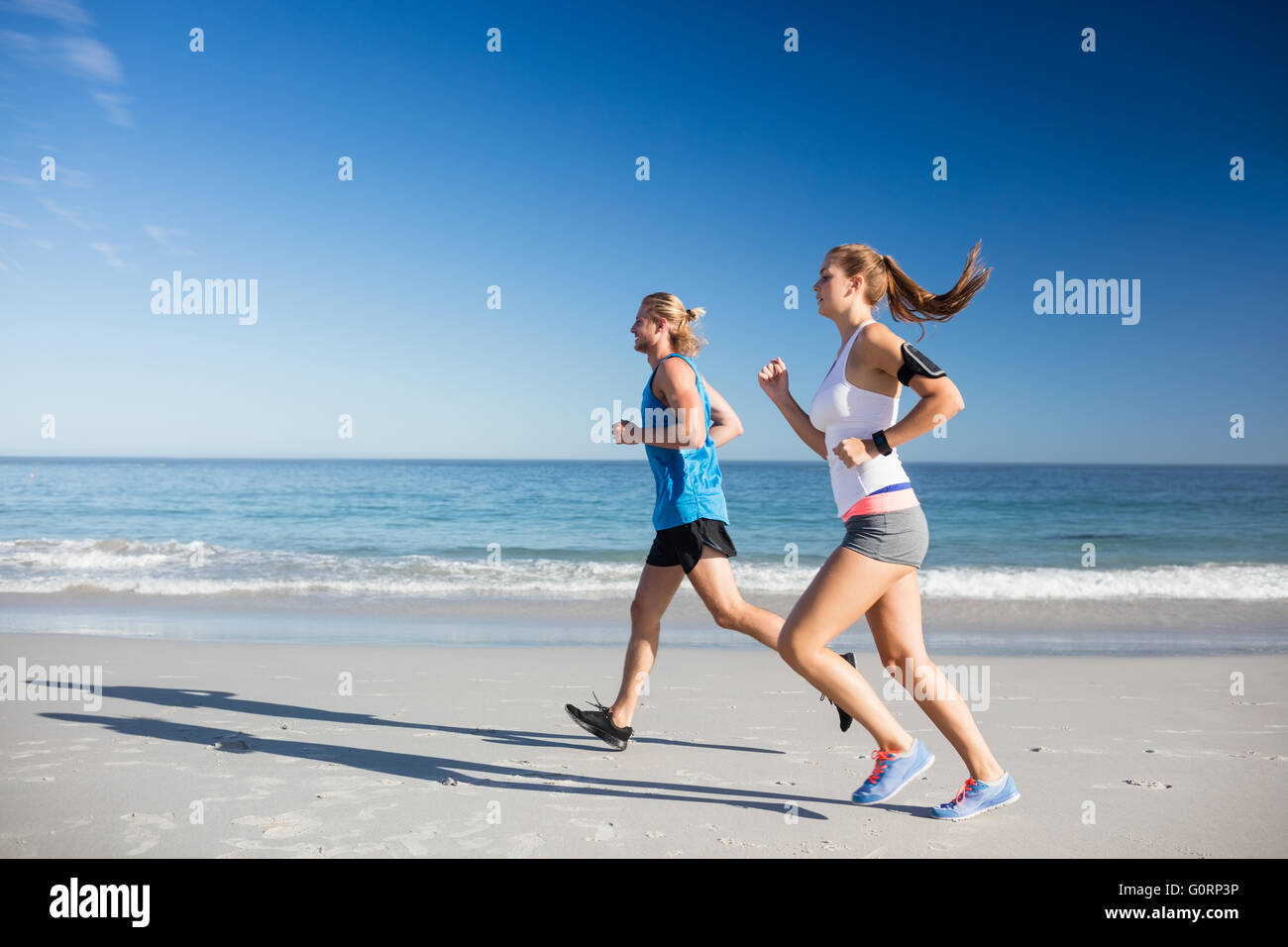Friends jogging at the beach Stock Photo - Alamy