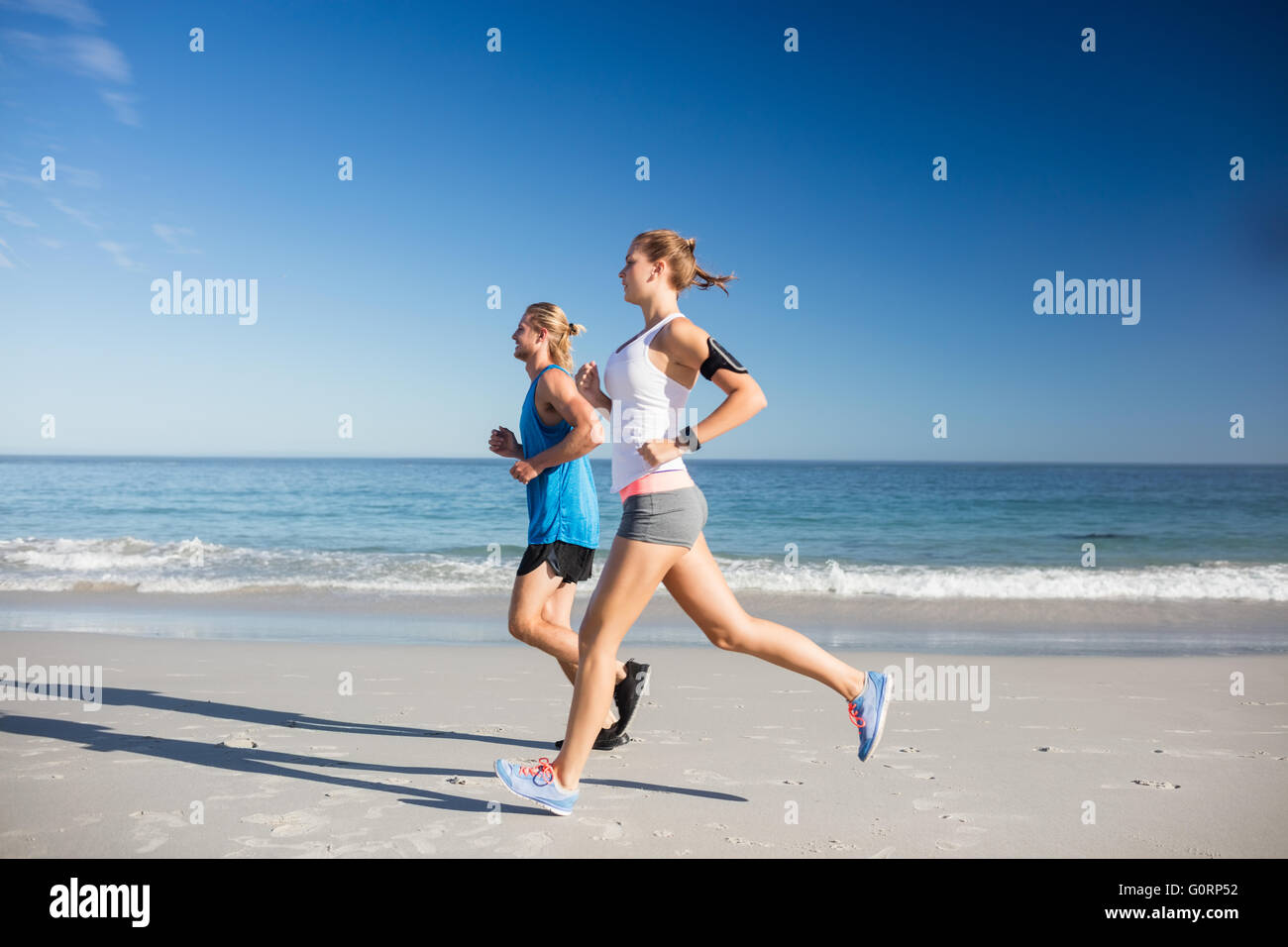 Friends jogging at the beach Stock Photo - Alamy
