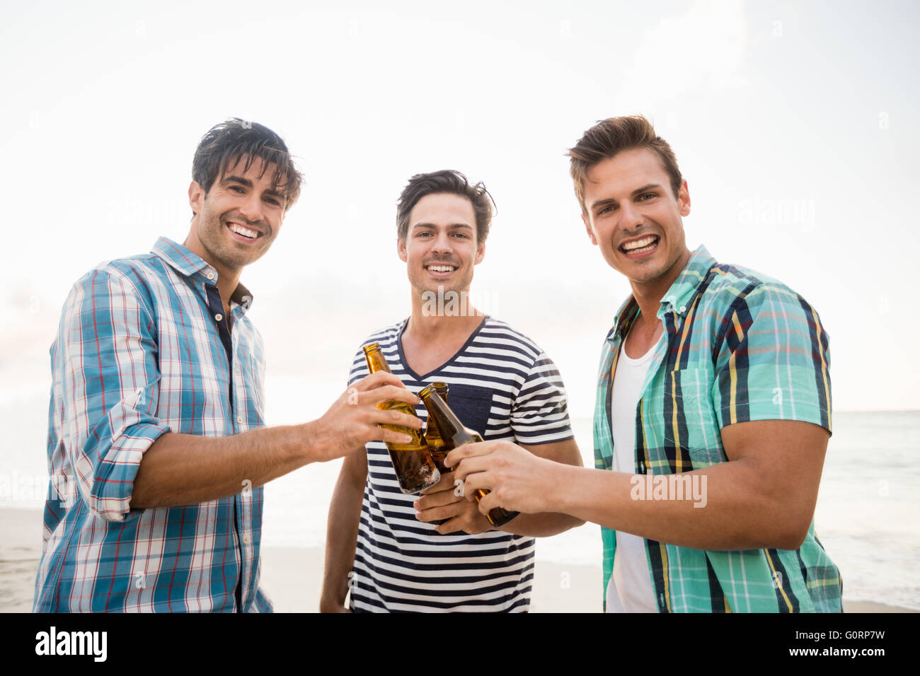 Friends cheering with beer Stock Photo - Alamy