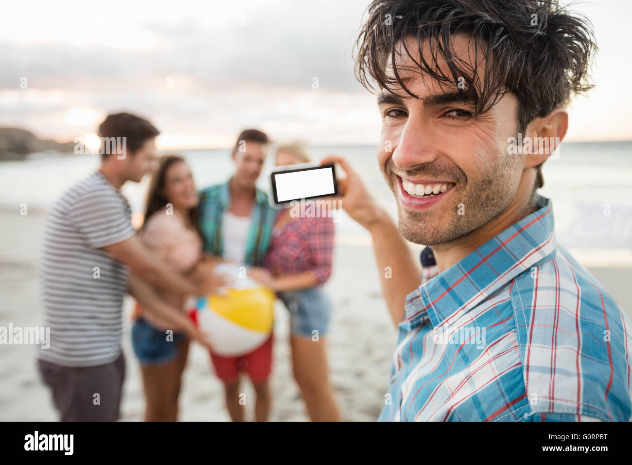 Friends taking a picture Stock Photo - Alamy