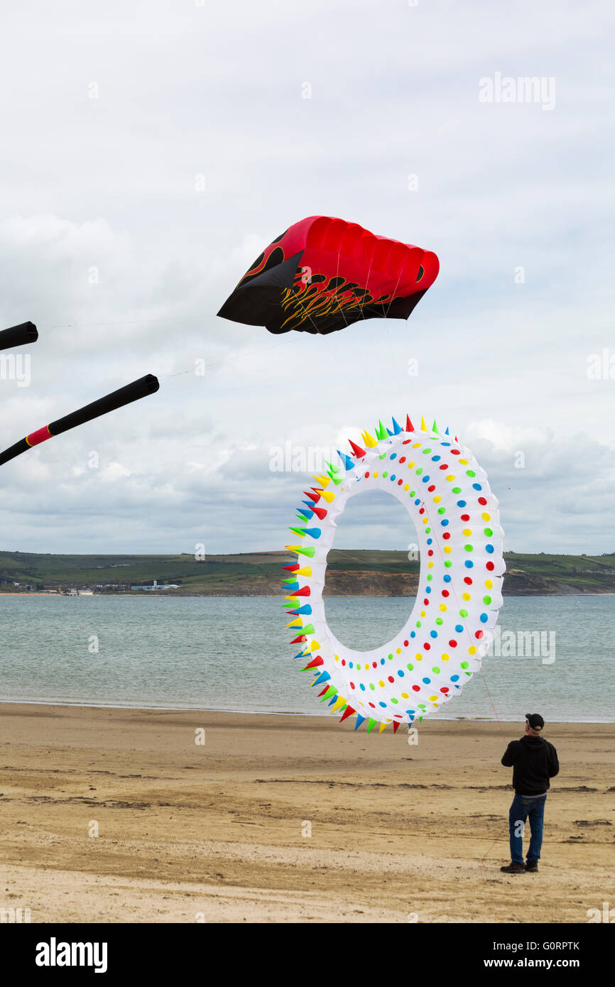 Man with ring circular kite with coloured spikes flying at the Weymouth ...