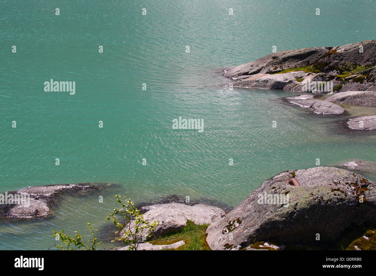Stones in pure blue glacial river in Norway Stock Photo - Alamy