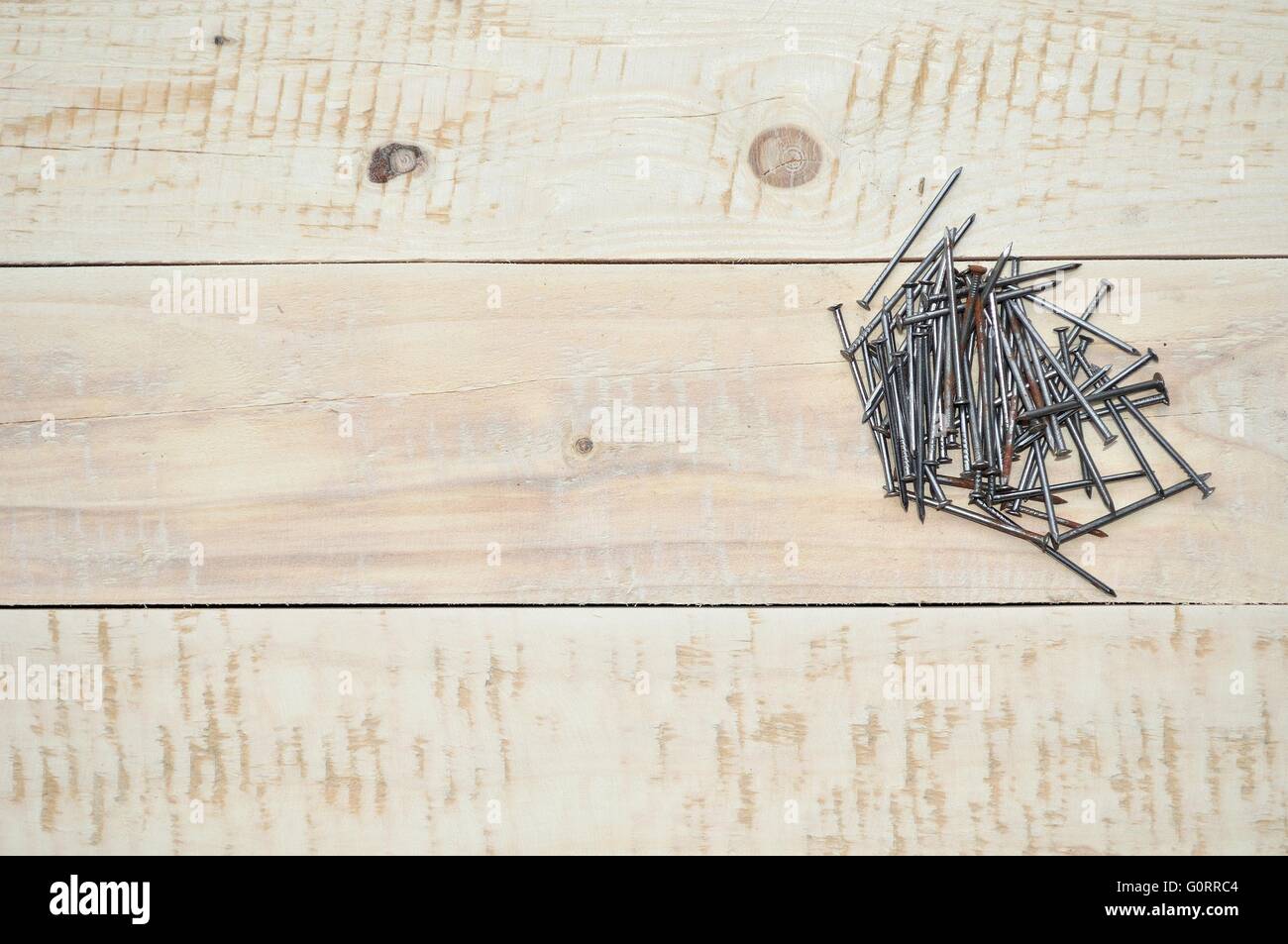 Nails on wood. Space on left side. Carpenter background Stock Photo - Alamy