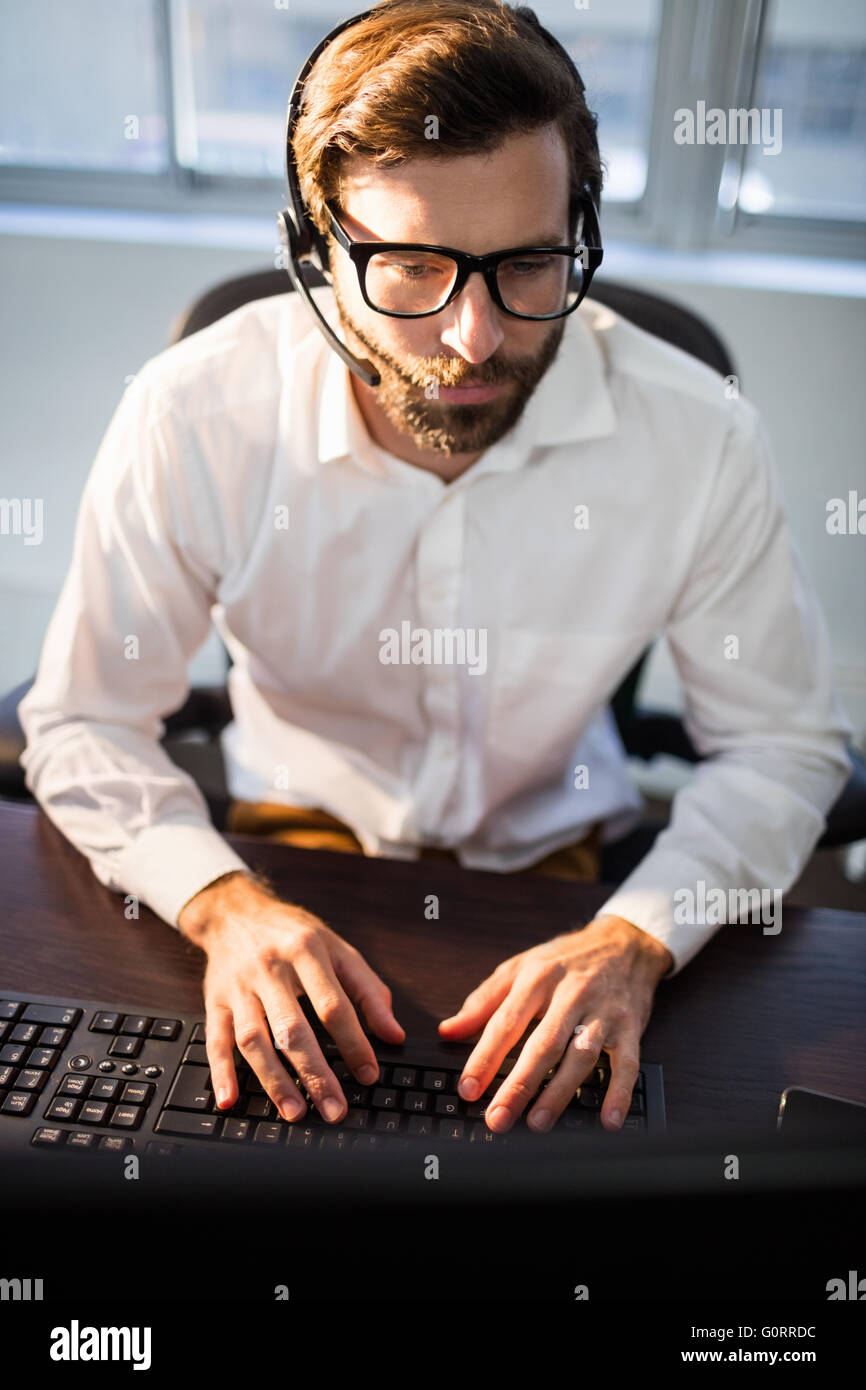 Businessman with glasses working on computer Stock Photo - Alamy