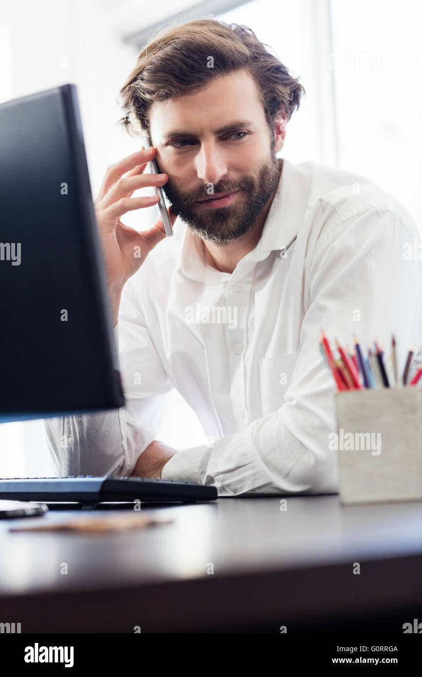 A man passing a call in front of this desk at the office Stock Photo ...
