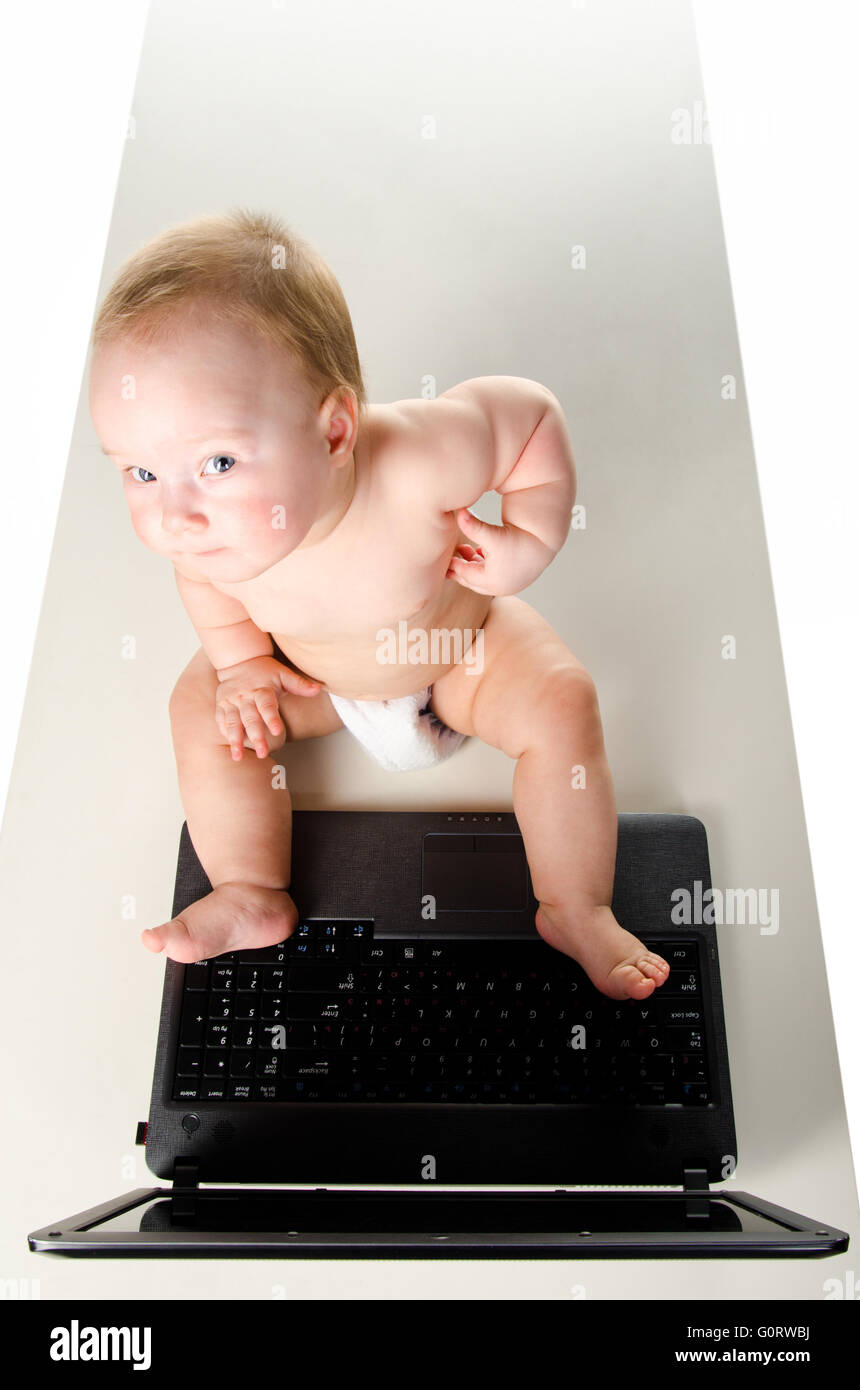 little baby is working on laptop Stock Photo - Alamy