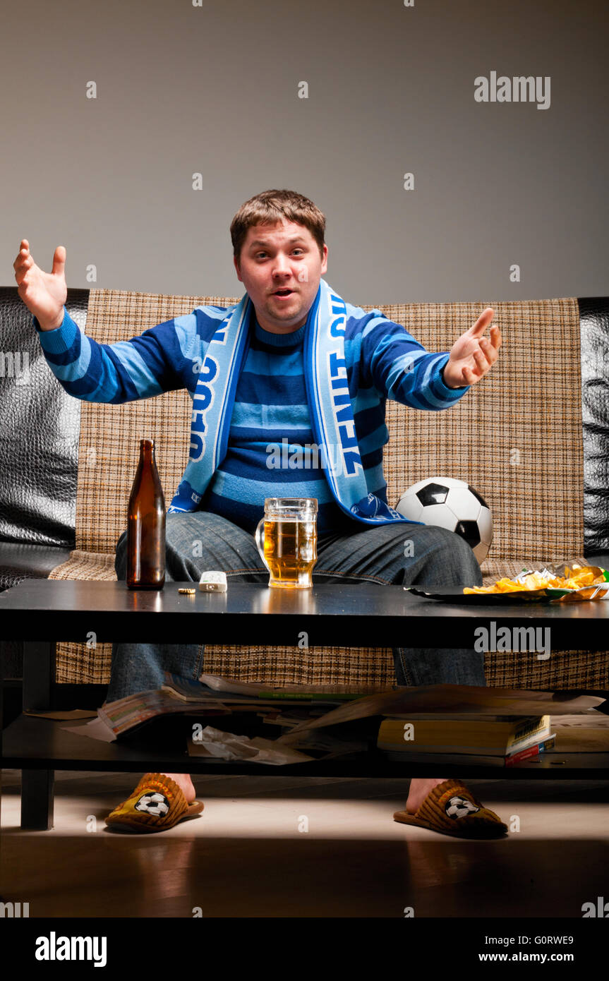 soccer fan on sofa Stock Photo - Alamy