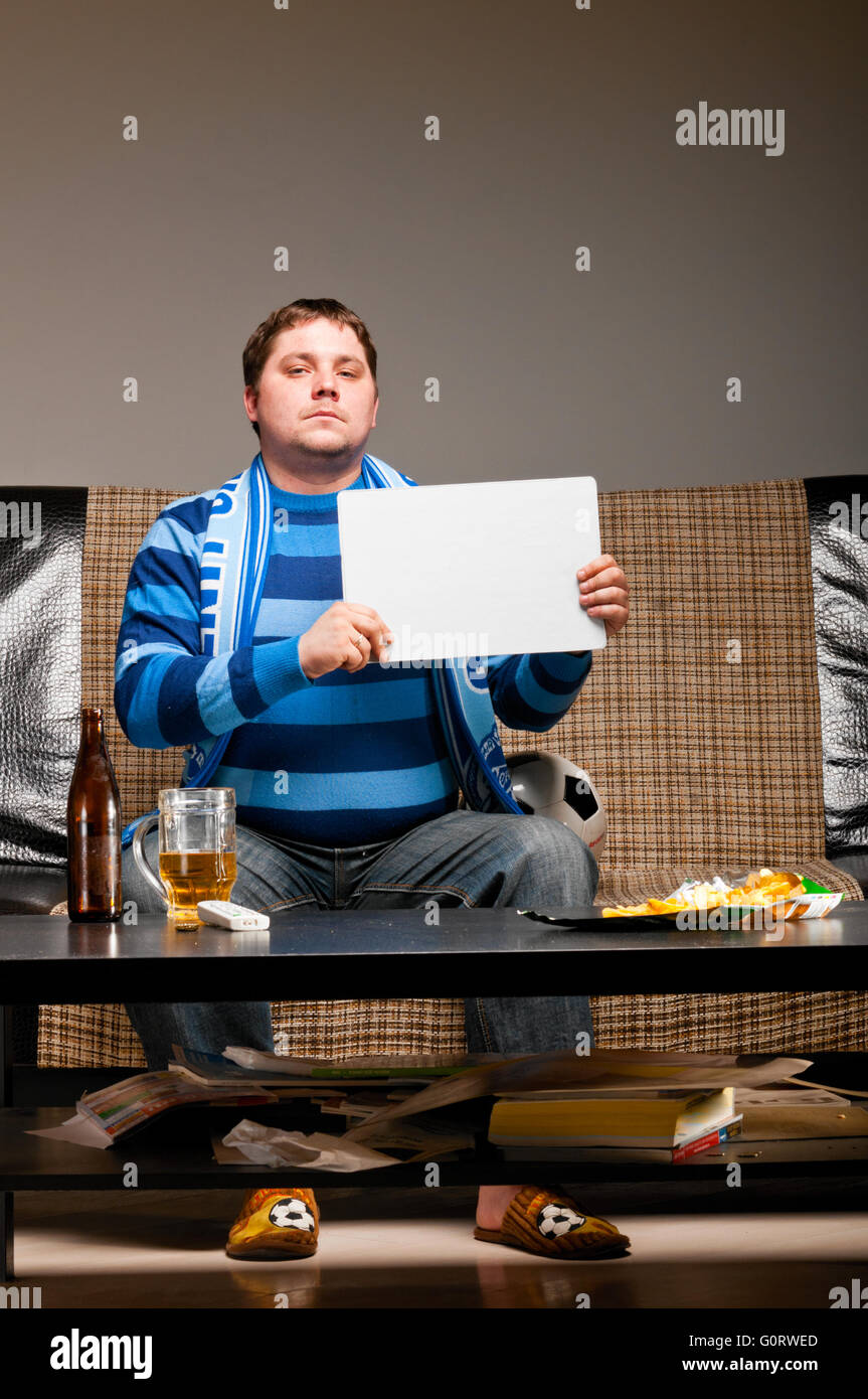soccer fan on sofa Stock Photo - Alamy