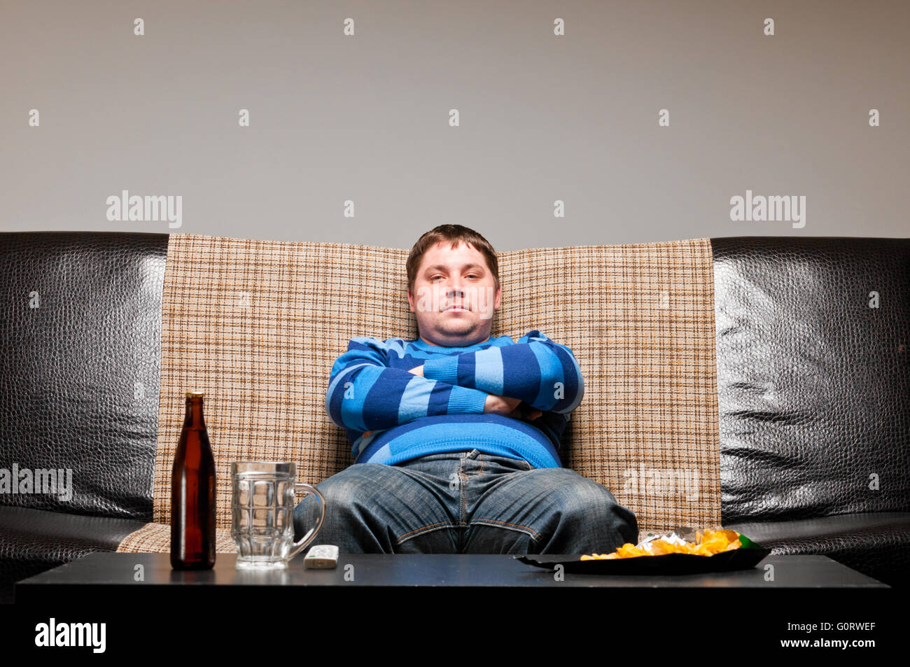 soccer fan on sofa Stock Photo - Alamy