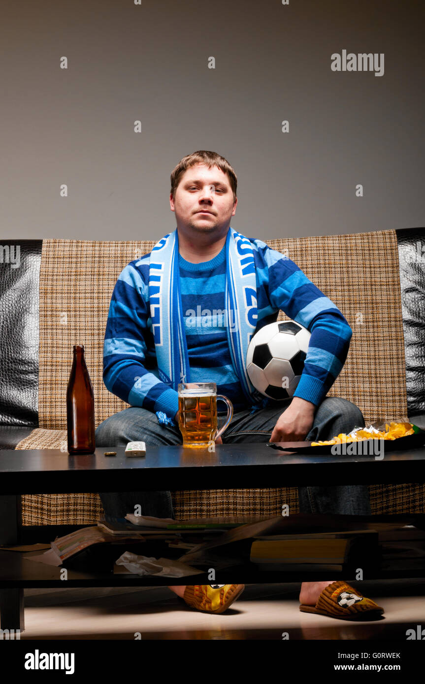 soccer fan on sofa Stock Photo - Alamy