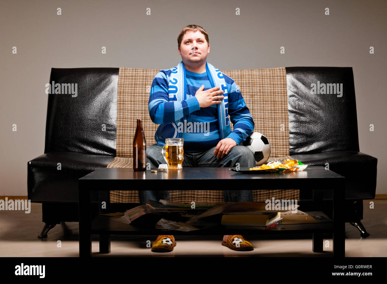 soccer fan on sofa Stock Photo - Alamy