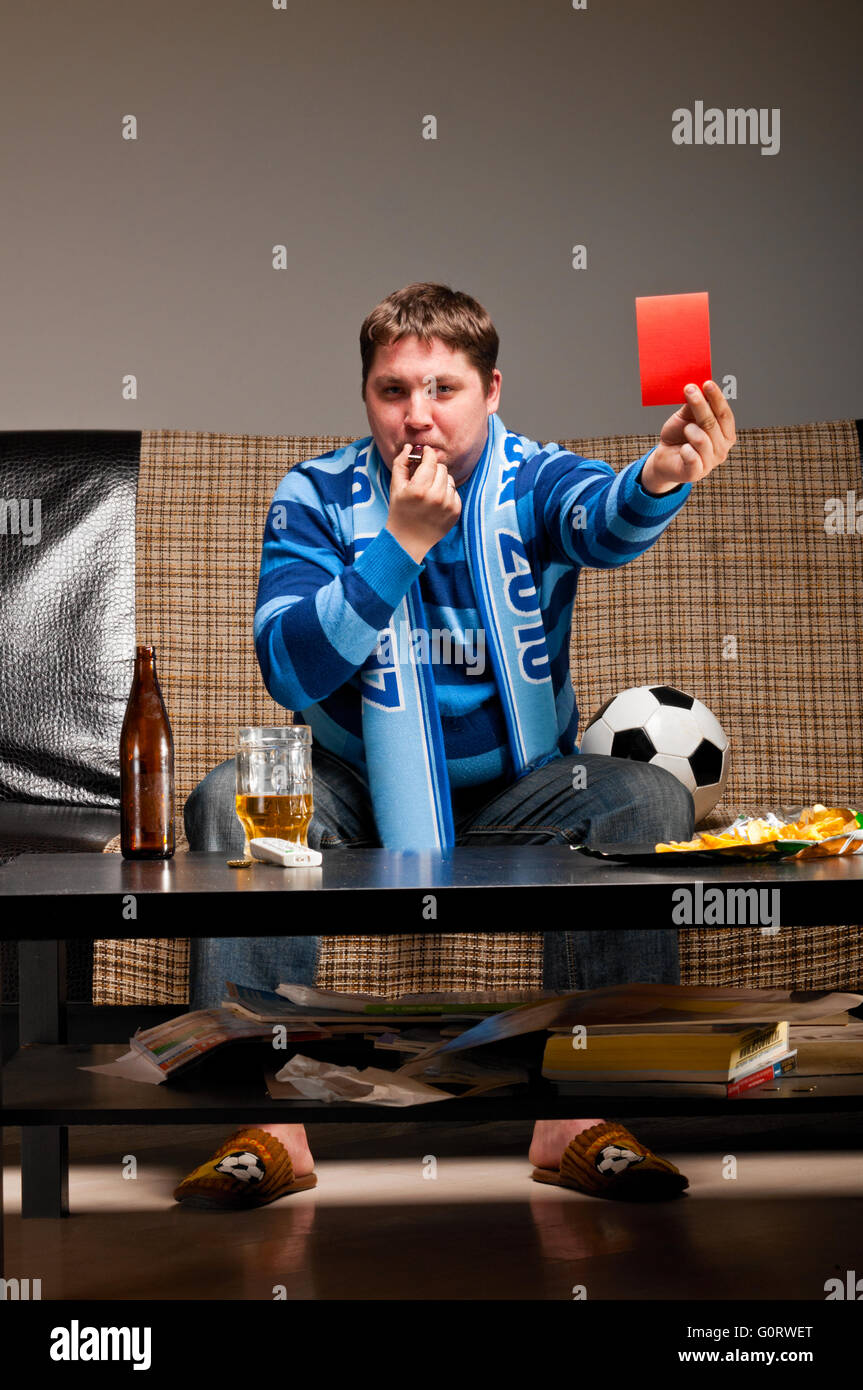 soccer fan on sofa Stock Photo - Alamy