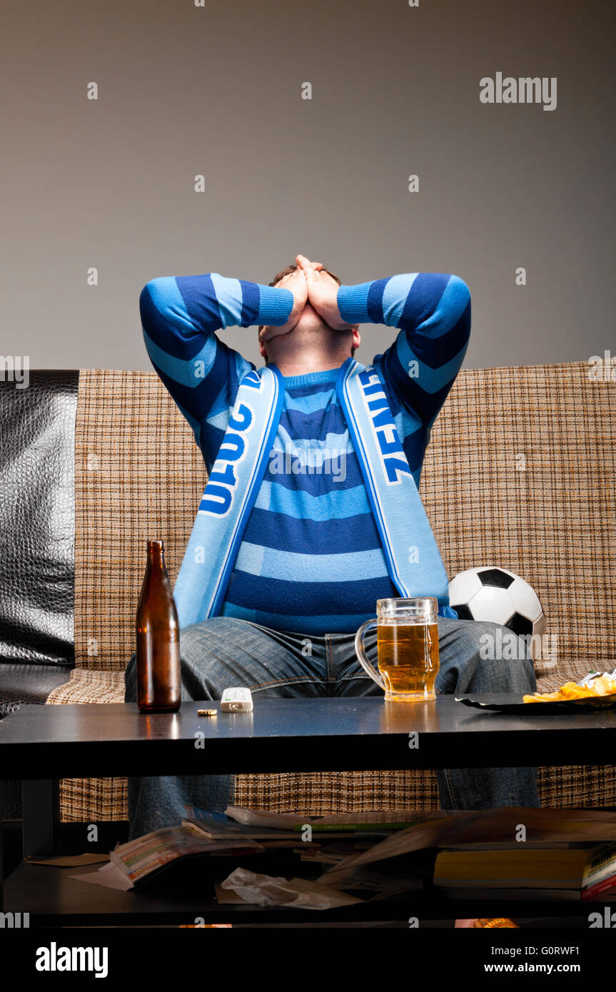 soccer fan on sofa Stock Photo - Alamy