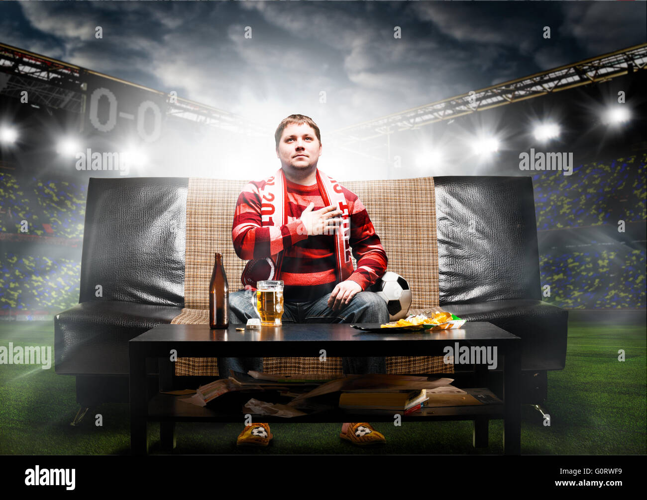 soccer fan on sofa Stock Photo - Alamy