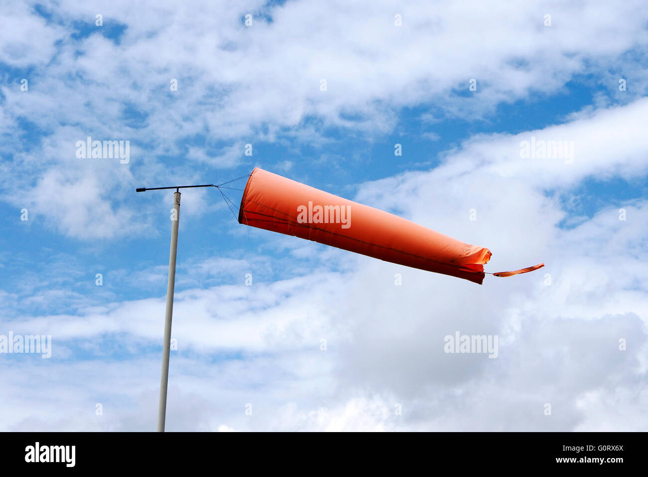 Bright orange wind sock fully extended showing wind speed above 15 ...