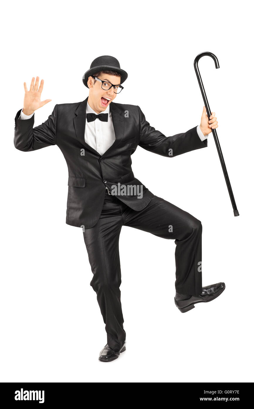 Full length portrait of a young male comedian dancing with a cane ...