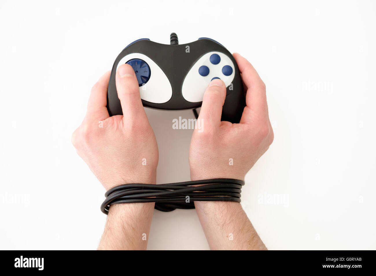 kid addicted by video-game playing with hands blocked by wired ...