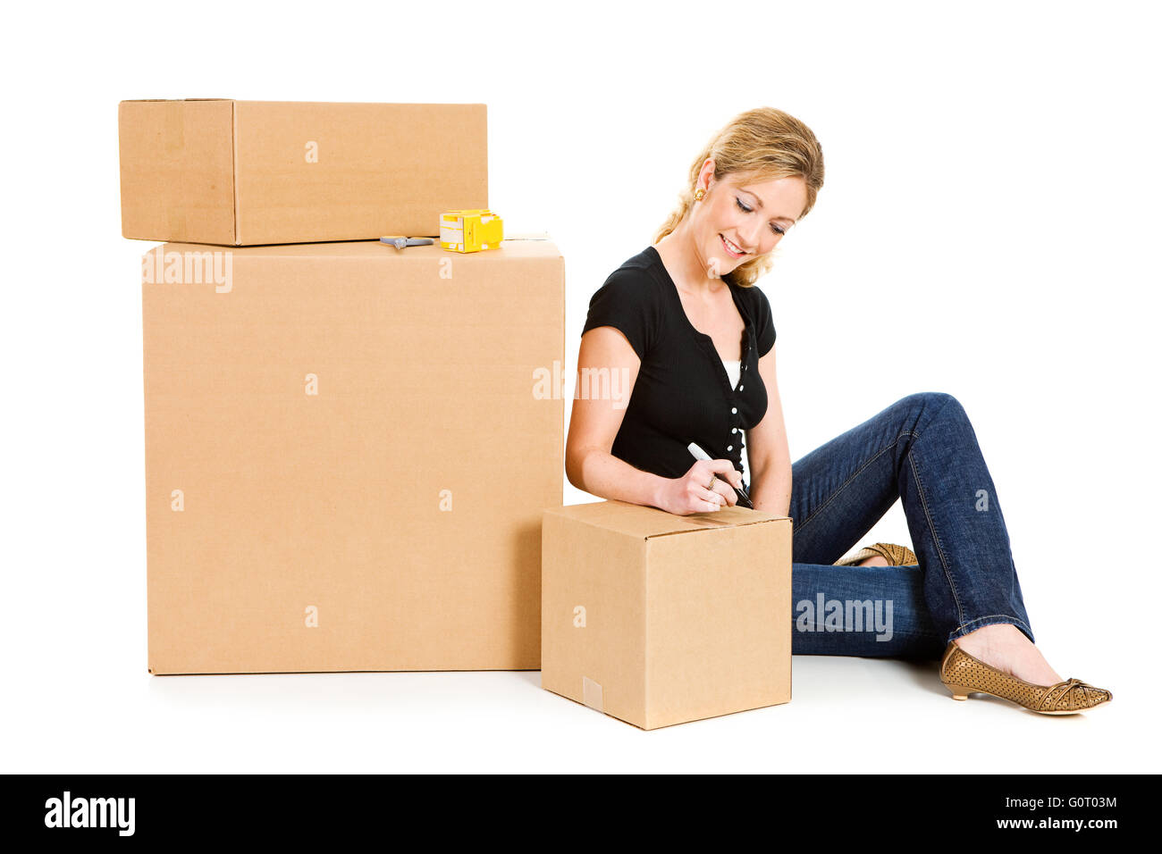 Happy woman packing boxes Cut Out Stock Images & Pictures - Alamy