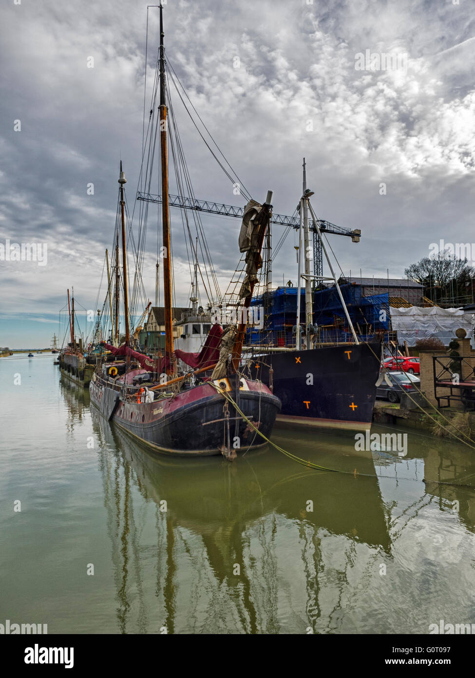 A colour, portrait photograph of some working sailing barges moored on ...