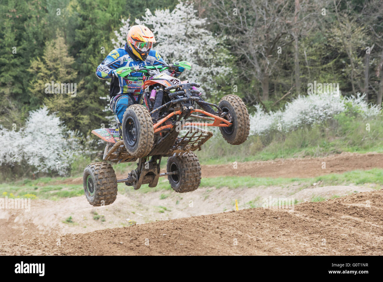 Closeup of quad rider in high jumping in the race Stock Photo - Alamy