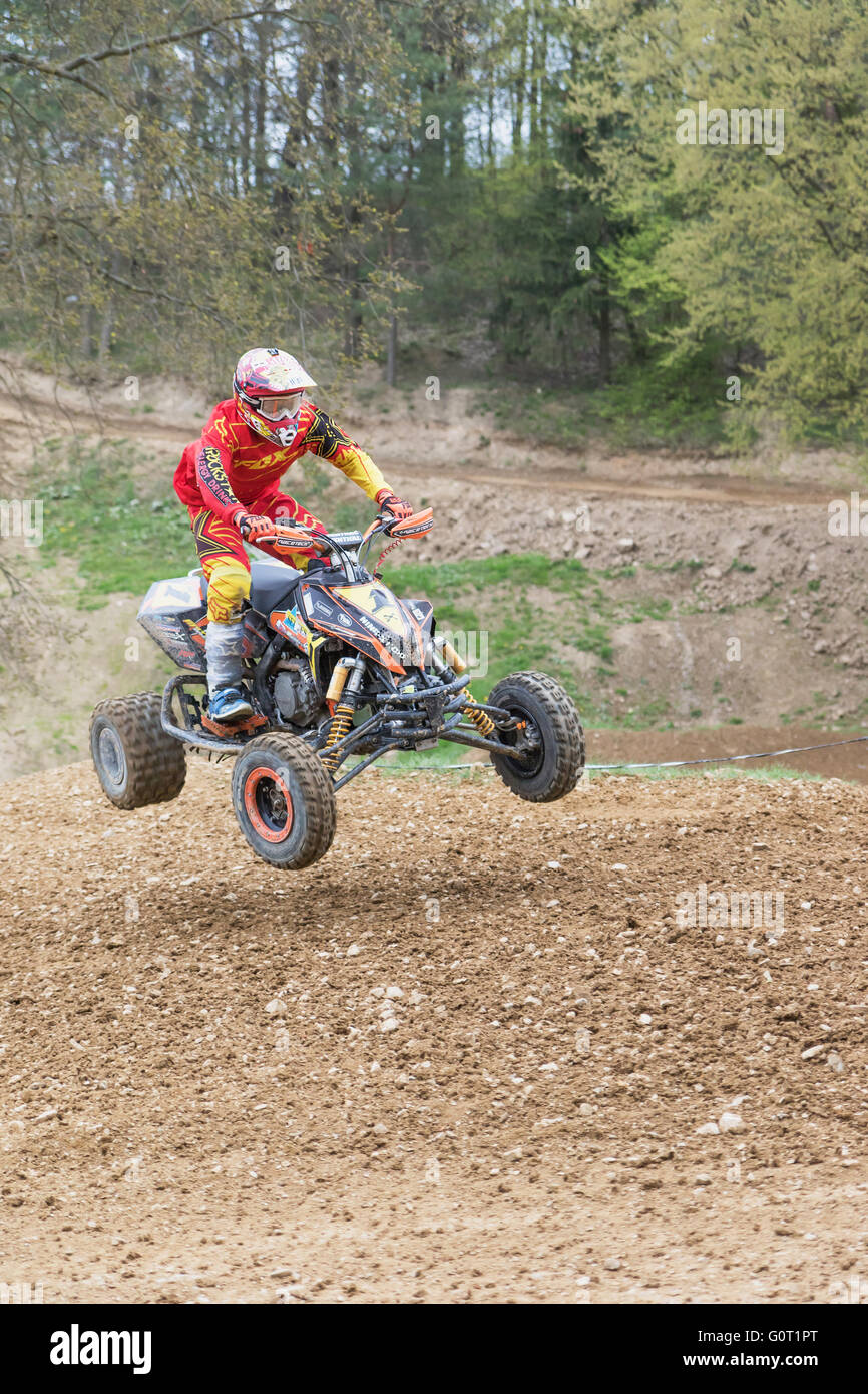 Quad rider before impact after the jump in the race. Vertically Stock ...