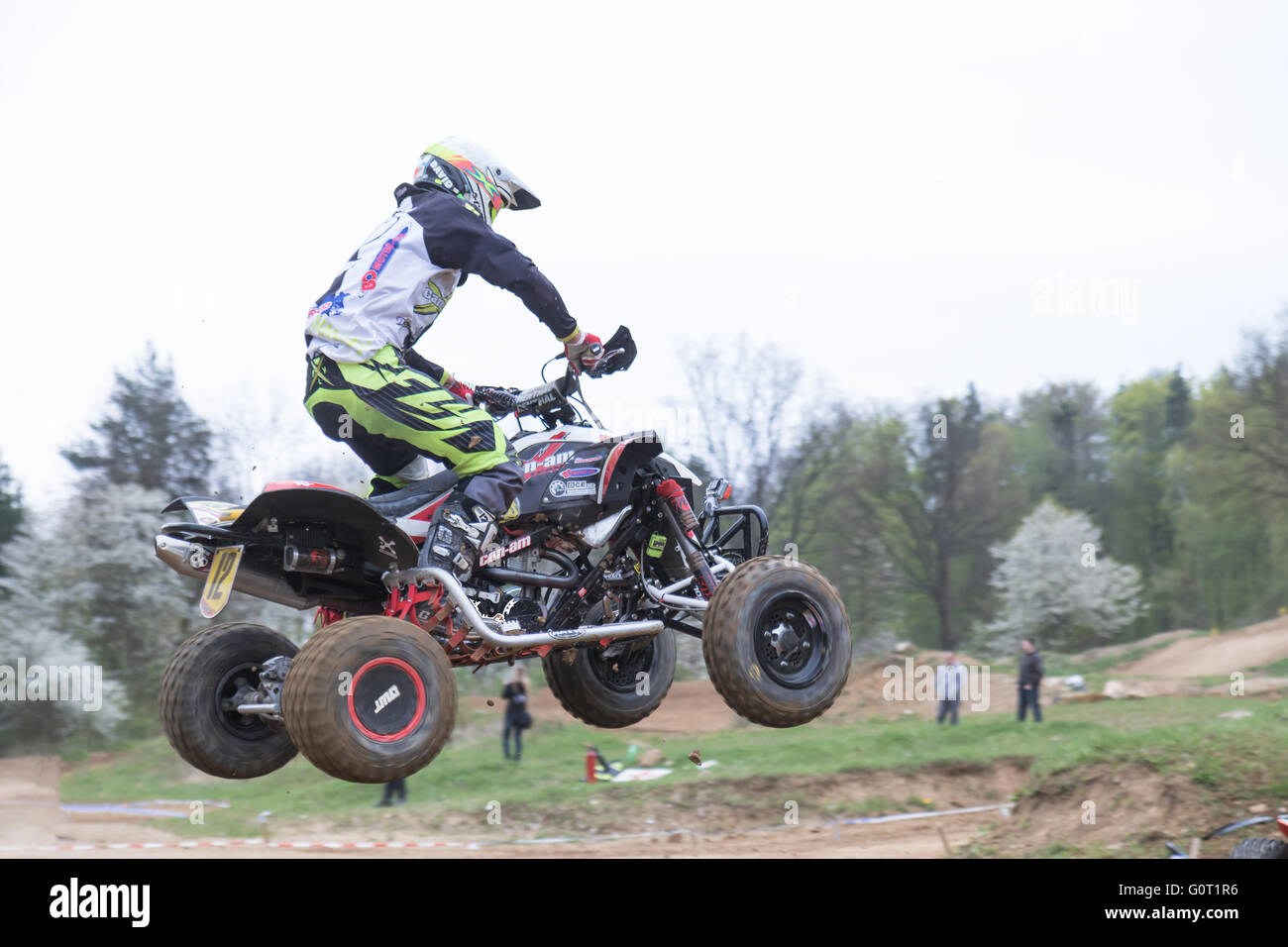 Rear view of quad rider in jumping Stock Photo - Alamy