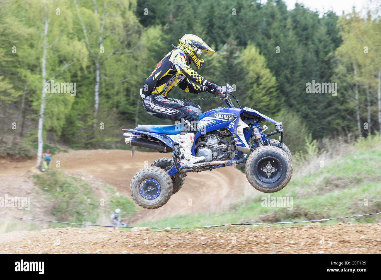 Dynamic shot of young quad rider jumping in terrain Stock Photo - Alamy