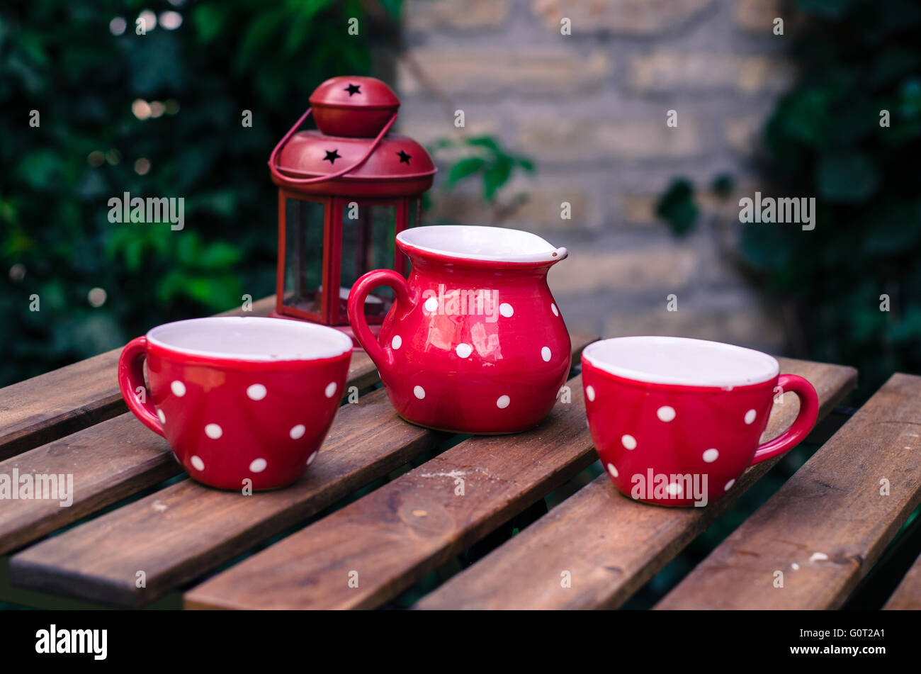 red tea set with white dots on the table concept Stock Photo - Alamy