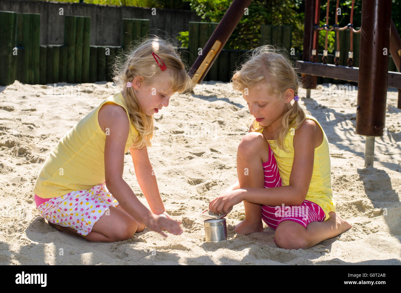 friendly girls playing in the sandbox Stock Photo - Alamy