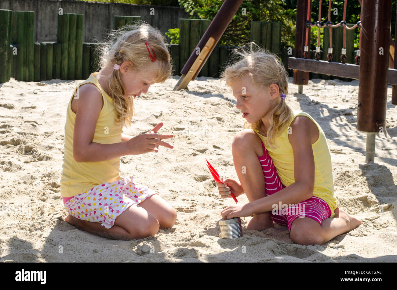 friendly girls playing in the sandbox Stock Photo - Alamy