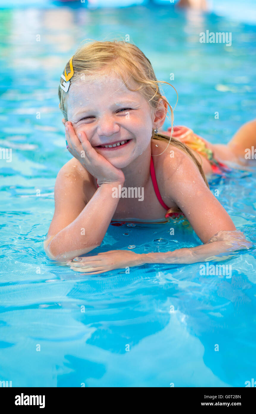 little kid smiling in the shallow water of the swimming pool Stock ...