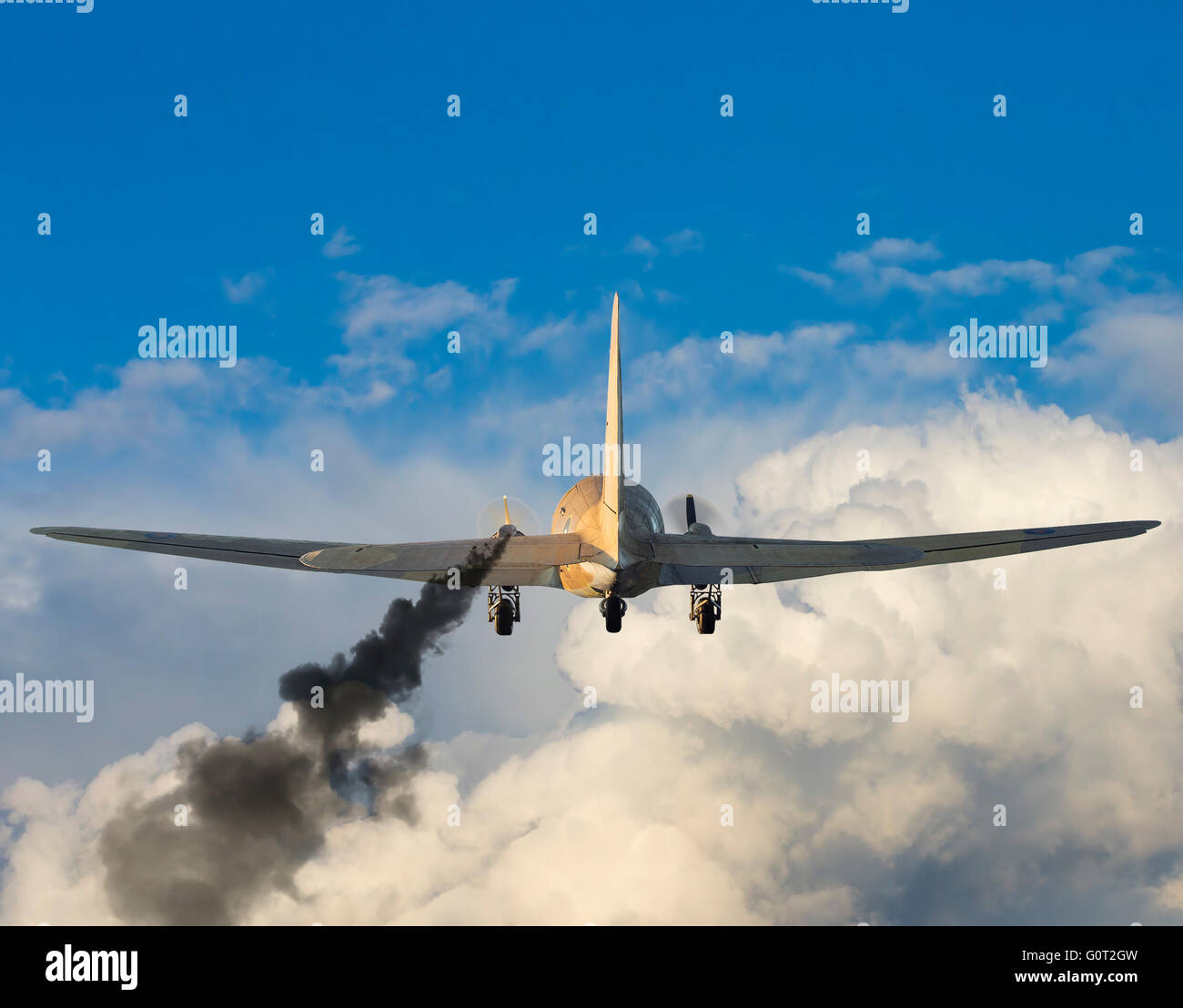 Damaged airplane with smoke coming from left engine Stock Photo - Alamy