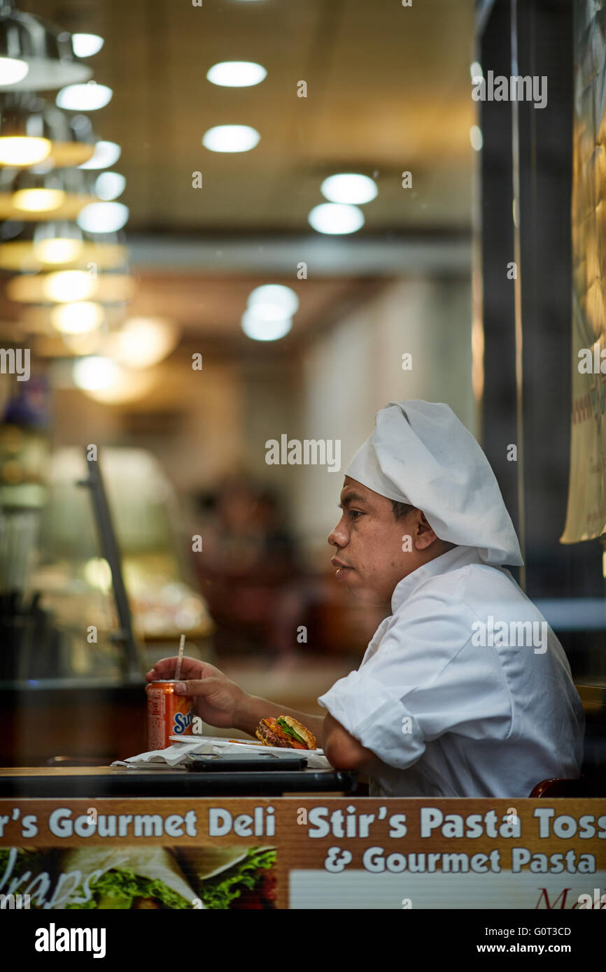 New york Chef in uniform resting break snack drinking soda can straw in ...