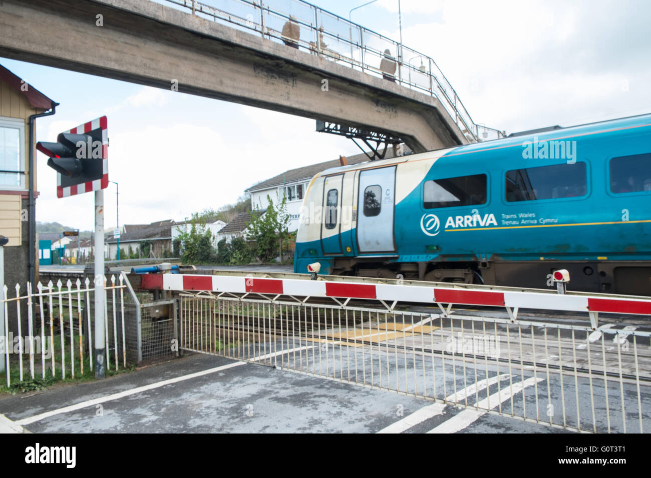 Arriva train passing barrier of a level crossing at Ferryside train ...