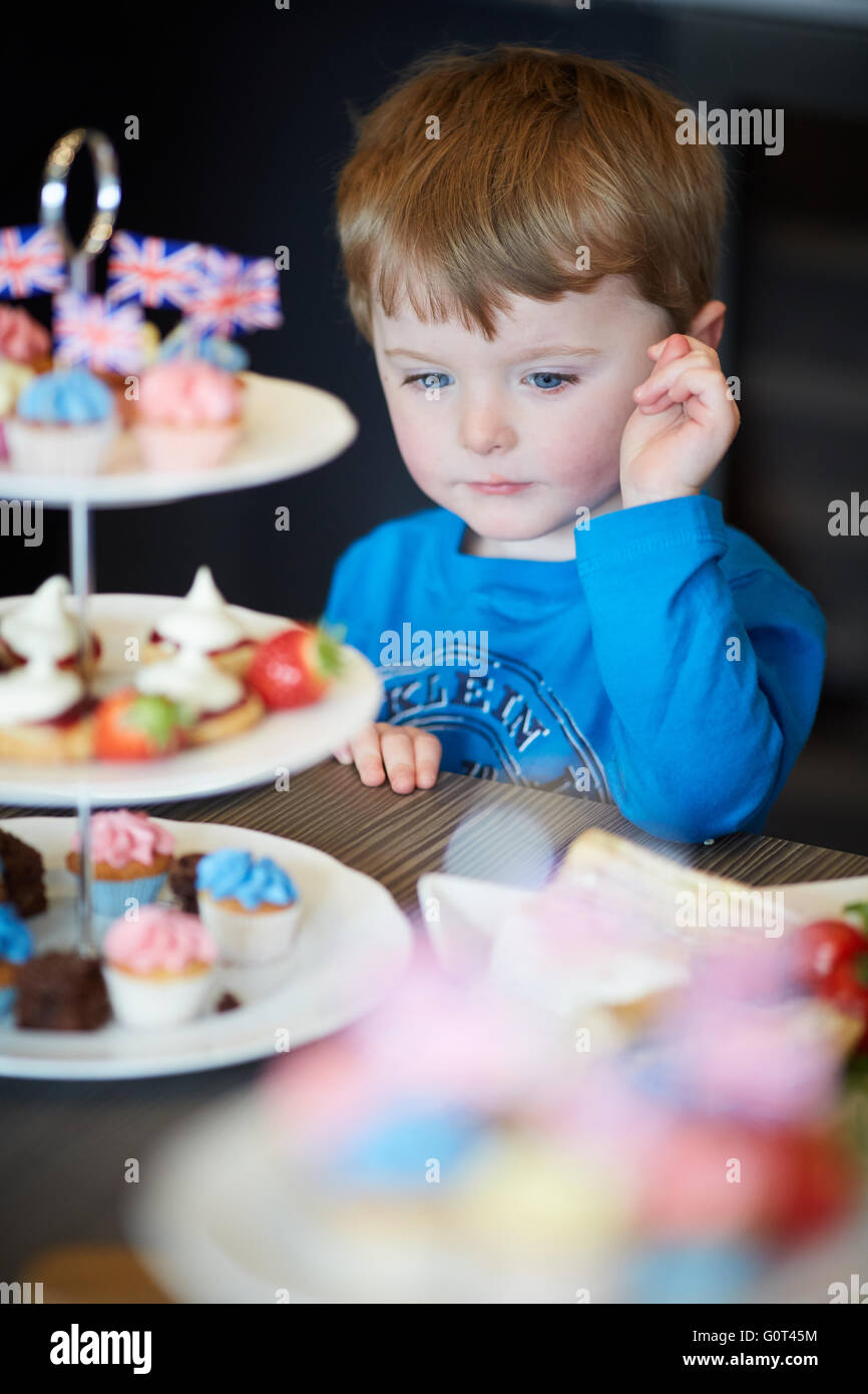 Young boy with cakes sweet tempted Man men male his him he lads boys ...