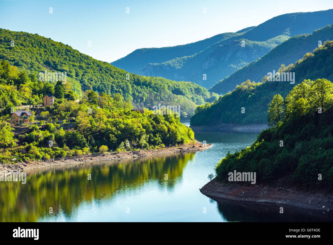 Landscape with lake between mountains covered in forest Stock Photo - Alamy