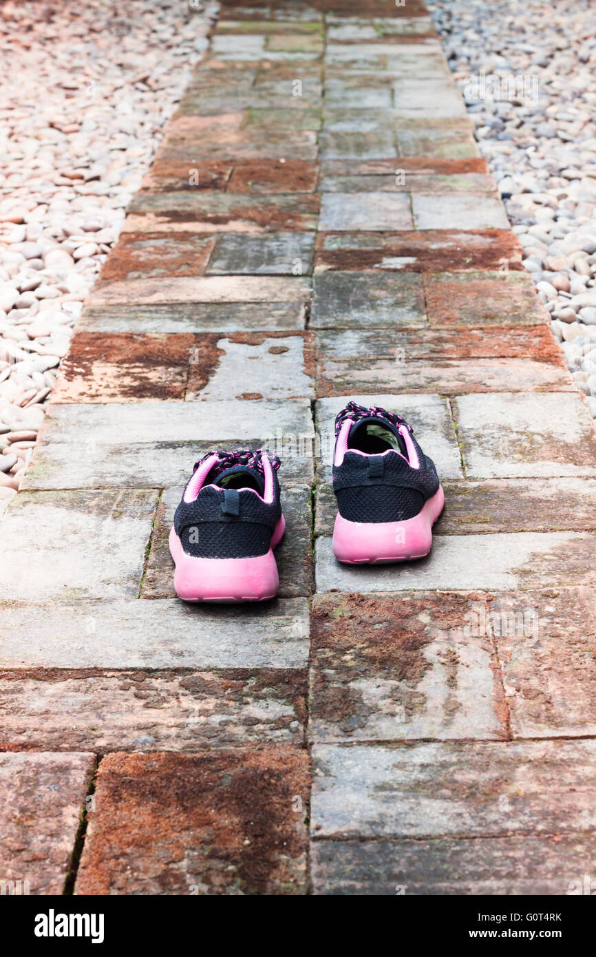 Running shoes in home garden foot path, stock photo Stock Photo - Alamy