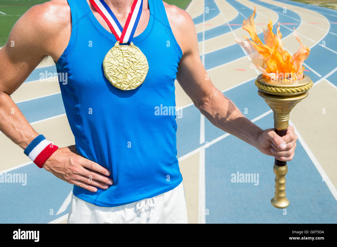 Gold medal athlete holding ceremonial sport torch with inspirational ...