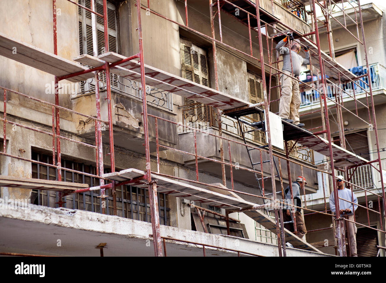 workers on a site, restoring an old building Stock Photo - Alamy