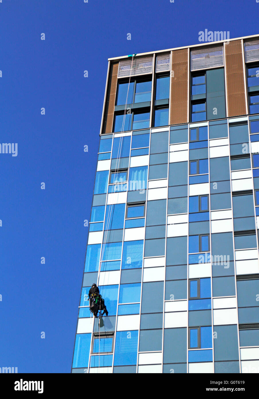 A window cleaner at work on a tower block in Norwich, Norfolk, England ...