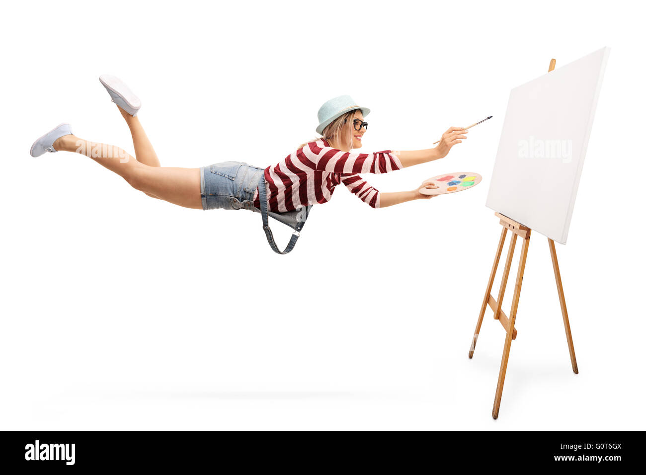 Flying female artist with a paintbrush and an easel isolated on white ...